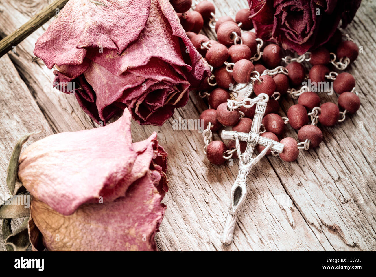 Praying Hands With Rosary And Roses