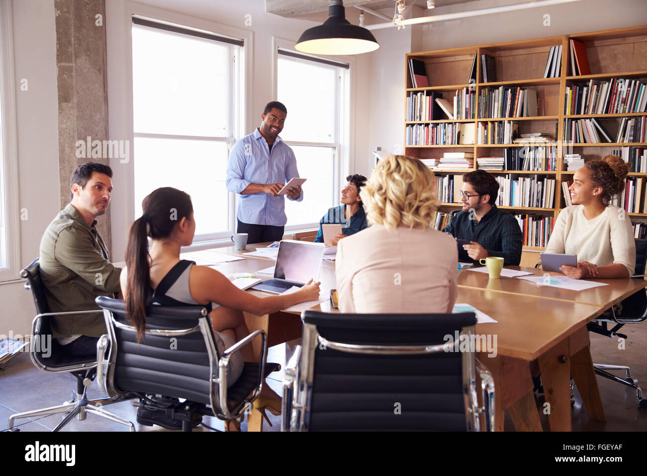 Businessman Addressing Team Meeting Around Table Stock Photo - Alamy
