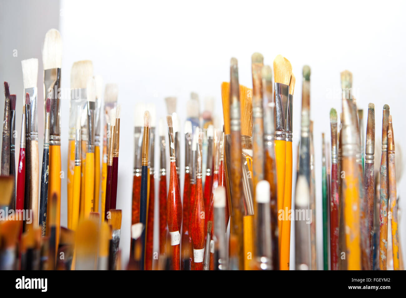 Artists brushes and paint container Stock Photo - Alamy