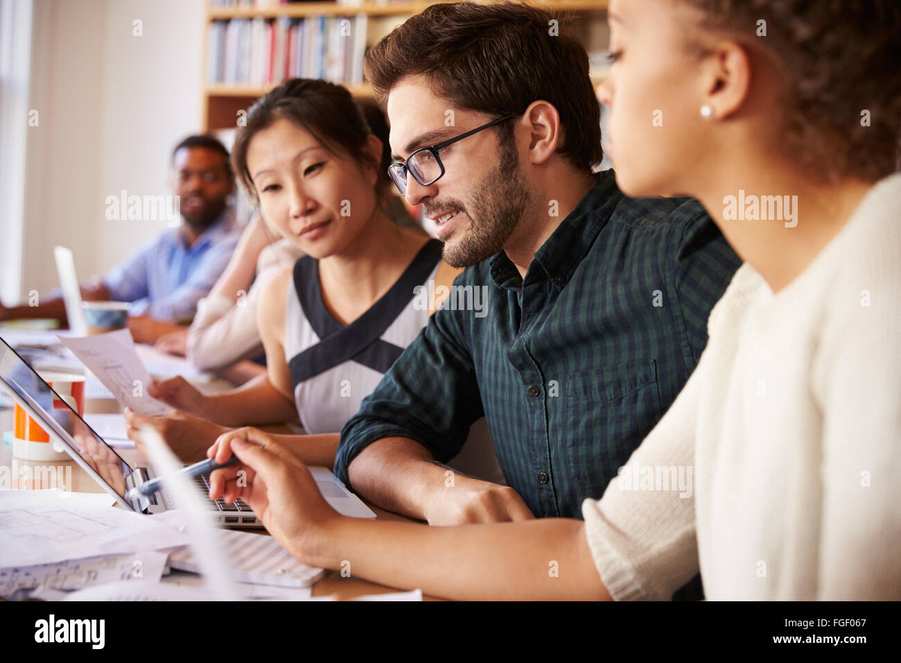 Business Team Having Meeting In Busy Office Stock Photo - Alamy