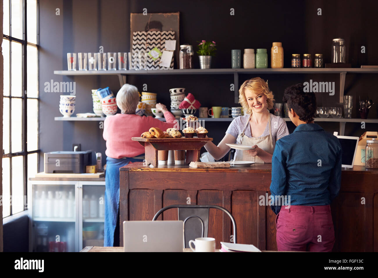 Staff Serving Customer In Busy Coffee Shop Stock Photo - Alamy