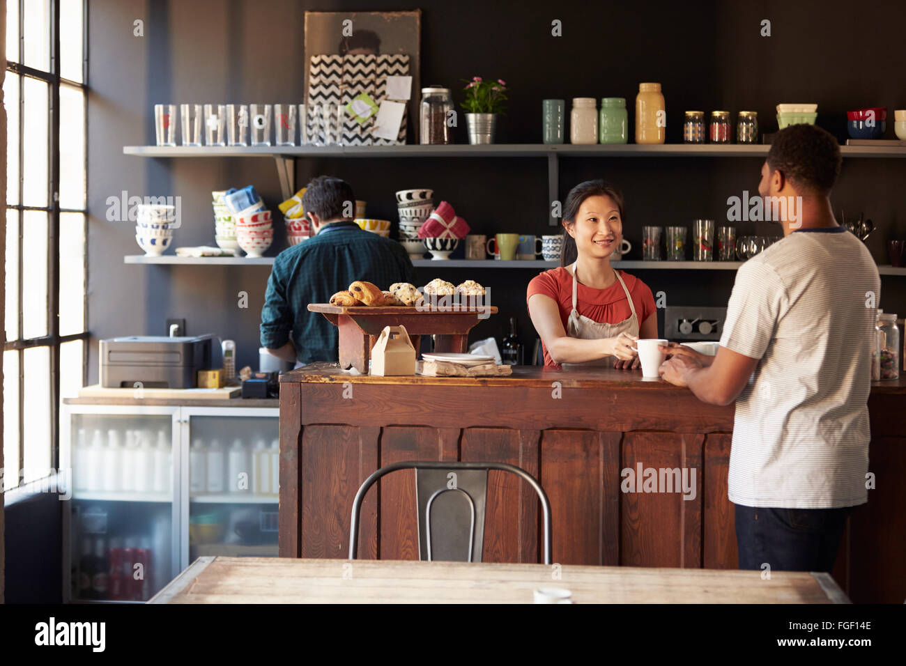 Staff Serving Customer In Busy Coffee Shop Stock Photo - Alamy