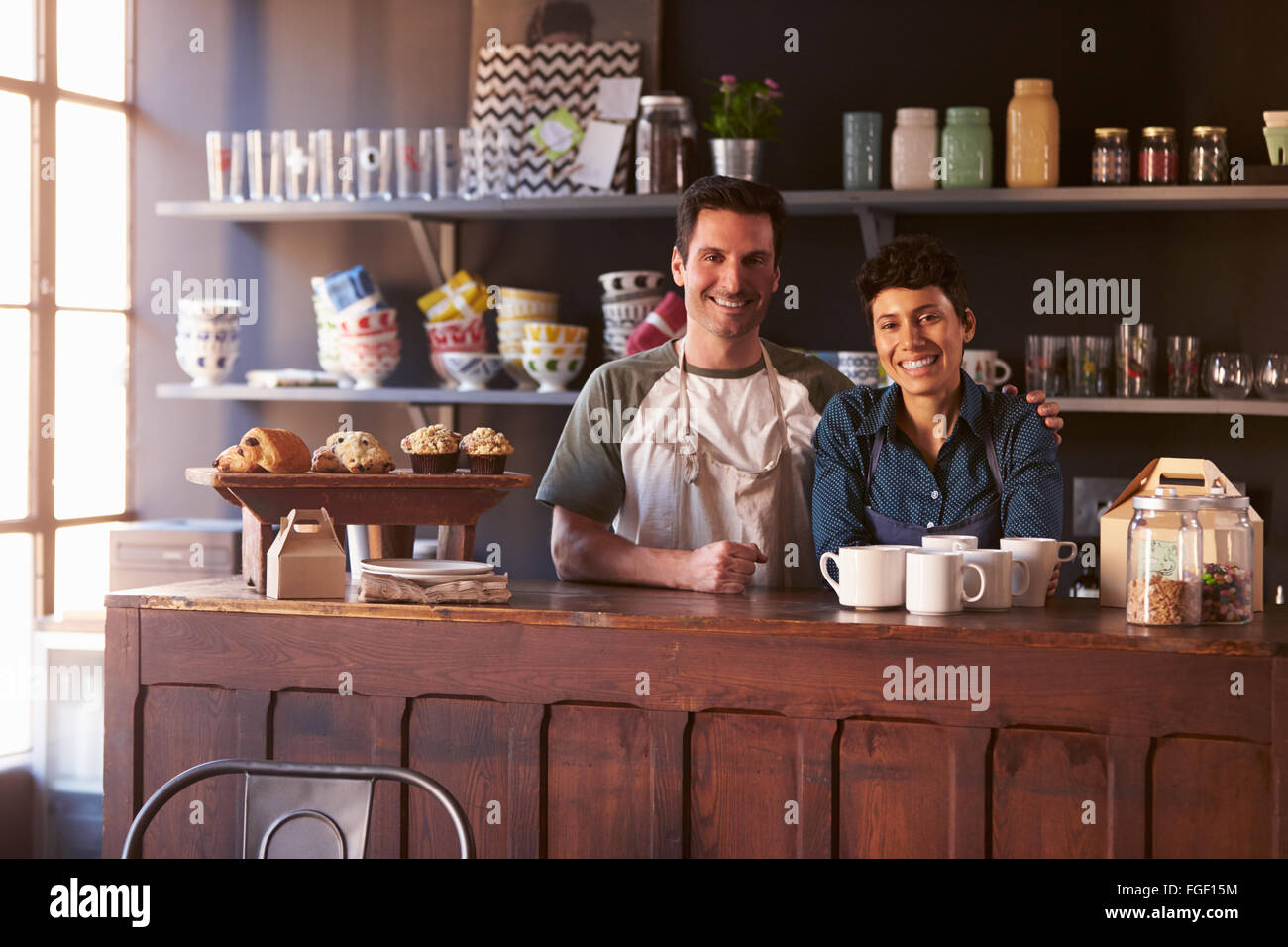 Portrait Of Couple Running Coffee Shop Behind Counter Stock Photo - Alamy