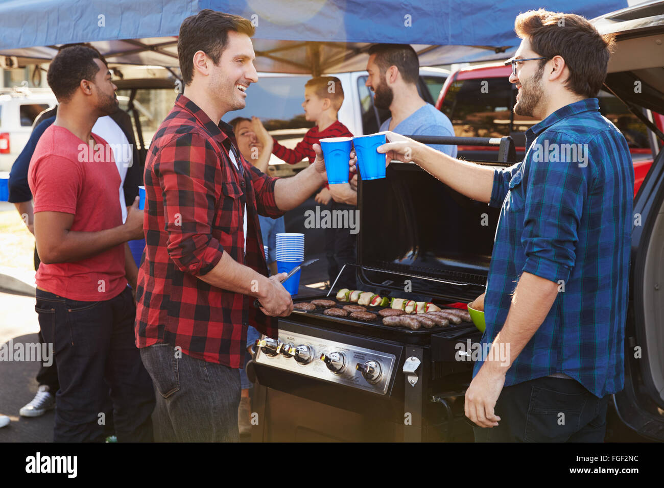 Group Of Sports Fans Tailgating In Stadium Car Park Stock Photo - Alamy