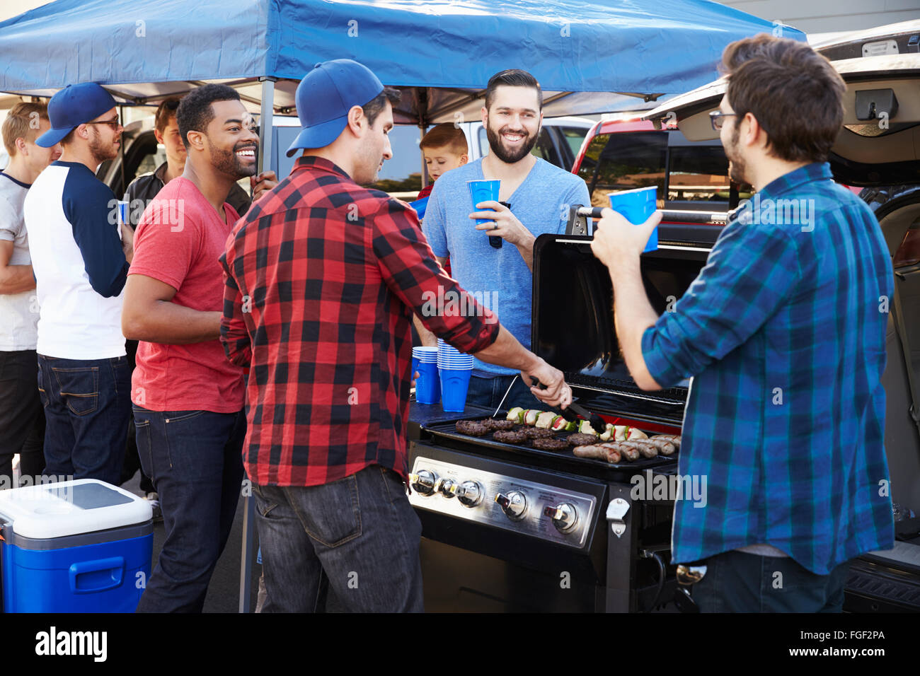 Group Of Sports Fans Tailgating In Stadium Car Park Stock Photo - Alamy