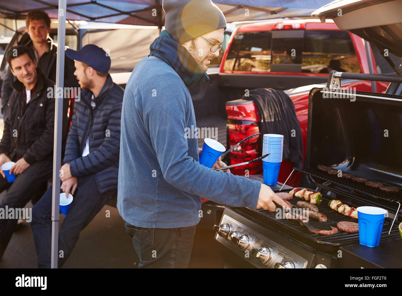 Group Of Sports Fans Tailgating In Stadium Car Park Stock Photo - Alamy