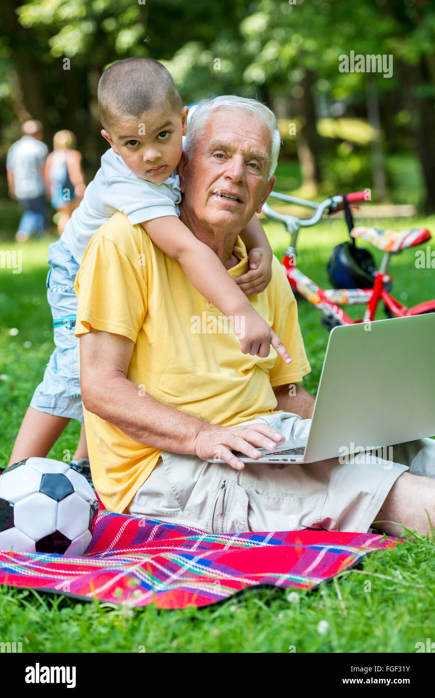 grandfather and child using laptop Stock Photo - Alamy