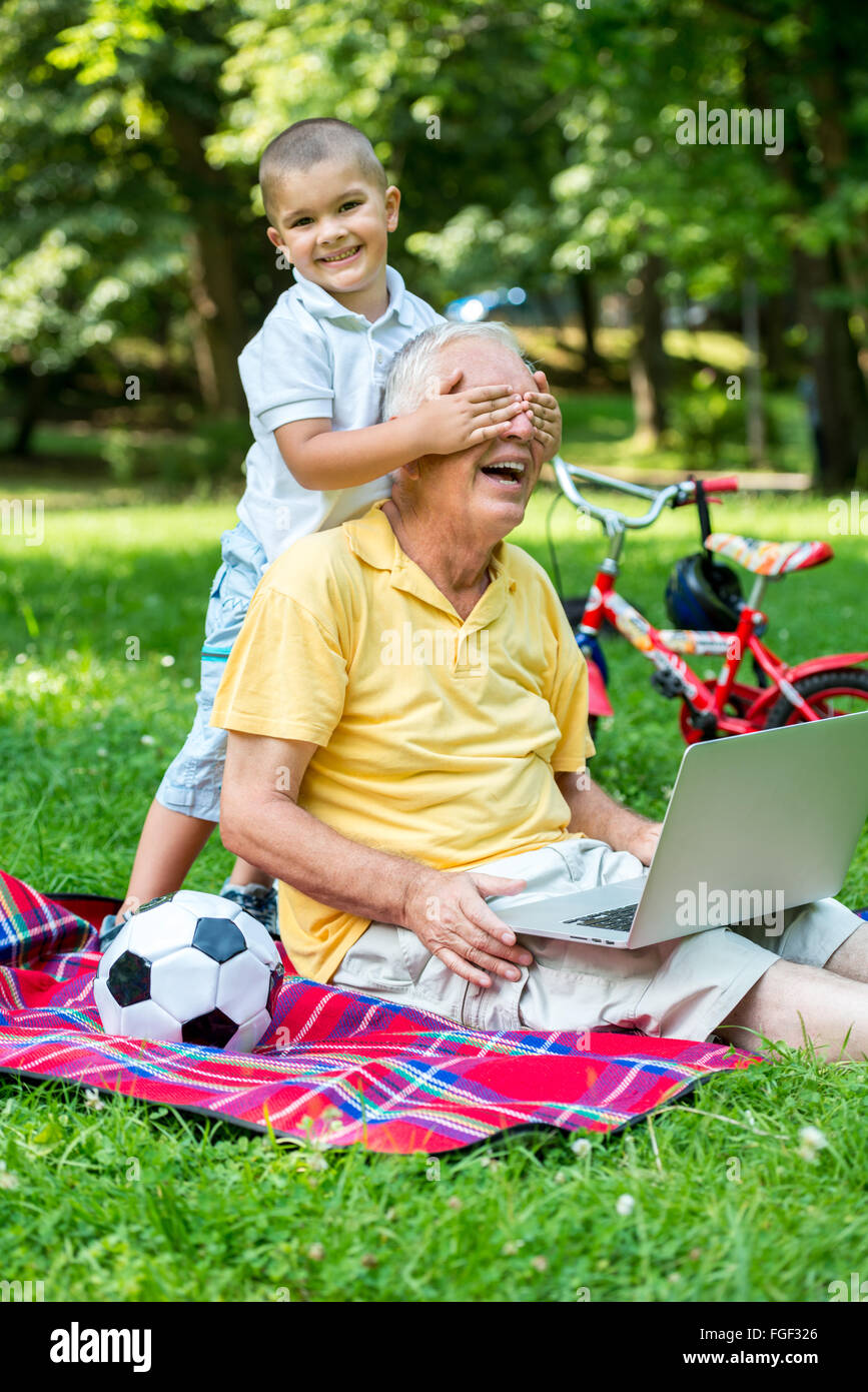 grandfather and child using laptop Stock Photo - Alamy