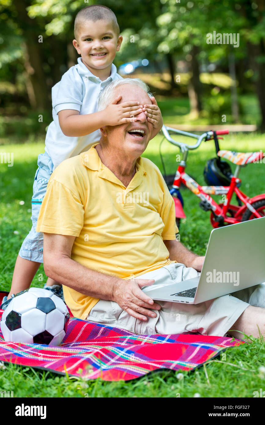 grandfather and child using laptop Stock Photo - Alamy
