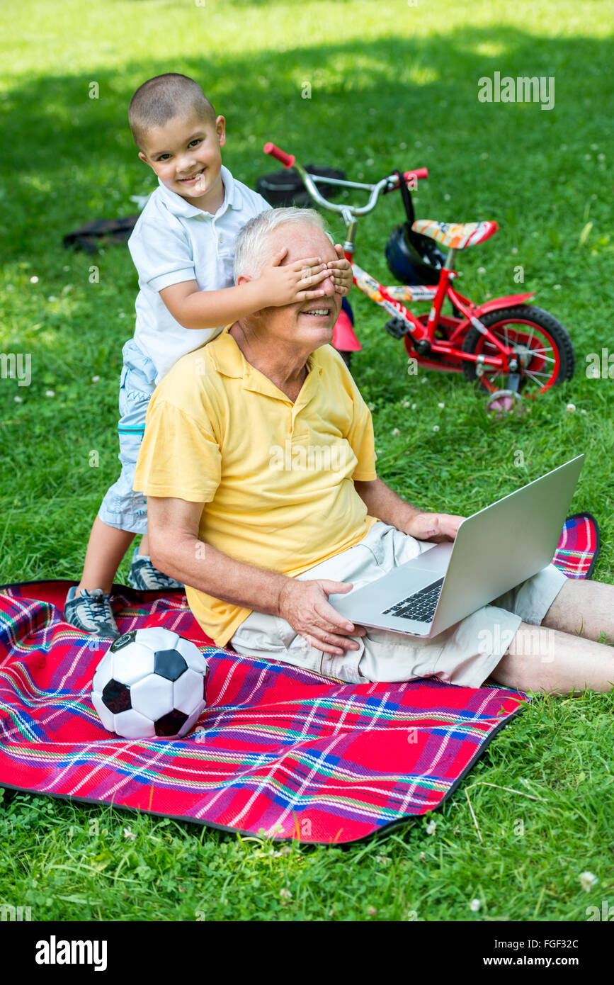 grandfather and child using laptop Stock Photo - Alamy
