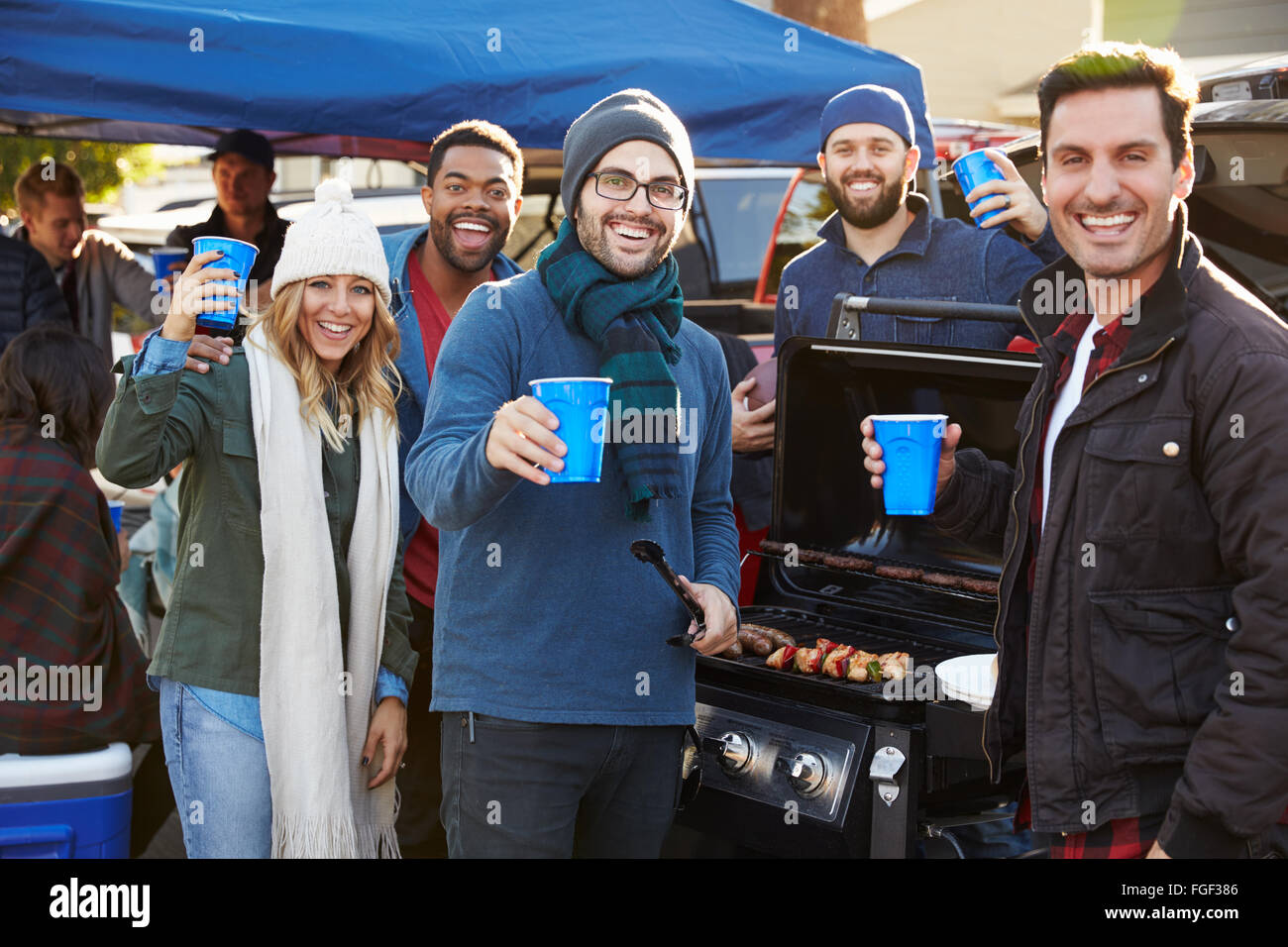 Group Of Sports Fans Tailgating In Stadium Car Park Stock Photo - Alamy