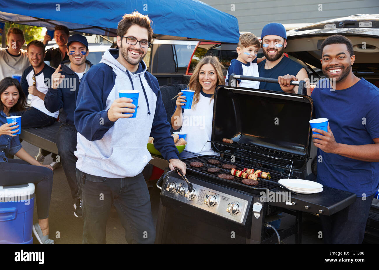Group Of Sports Fans Tailgating In Stadium Car Park Stock Photo - Alamy