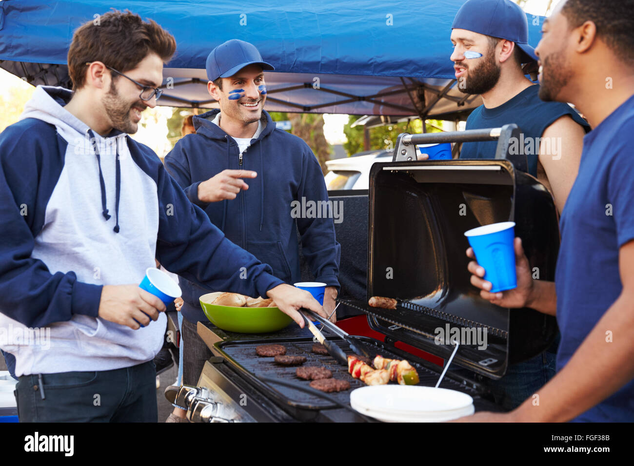 Group Of Male Sports Fans Tailgating In Stadium Car Park Stock Photo ...