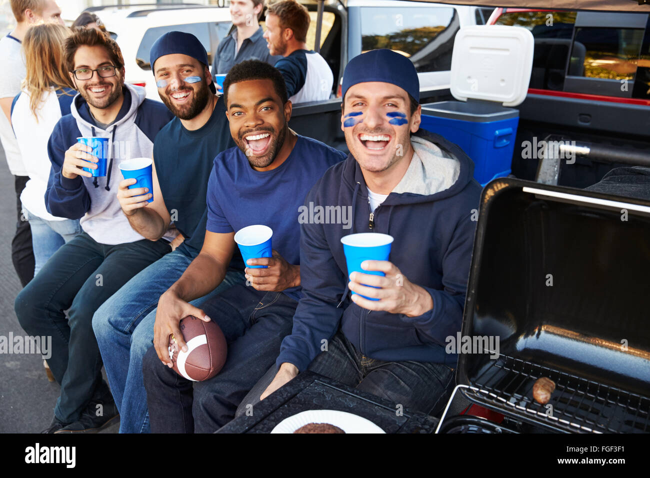 Group Of Sports Fans Tailgating In Stadium Car Park Stock Photo - Alamy