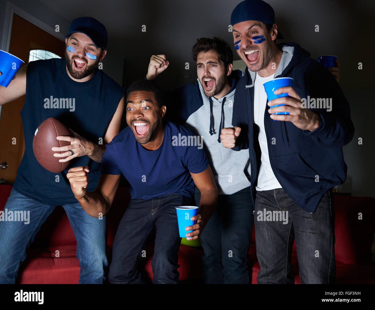 Group Of Male Sports Fans Watching Game On Television Stock Photo - Alamy