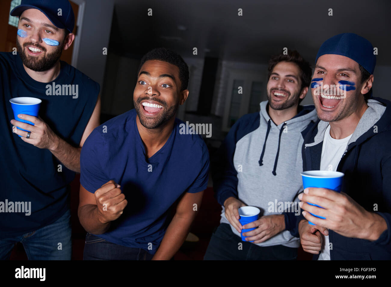 Group Of Male Sports Fans Watching Game On Television Stock Photo - Alamy