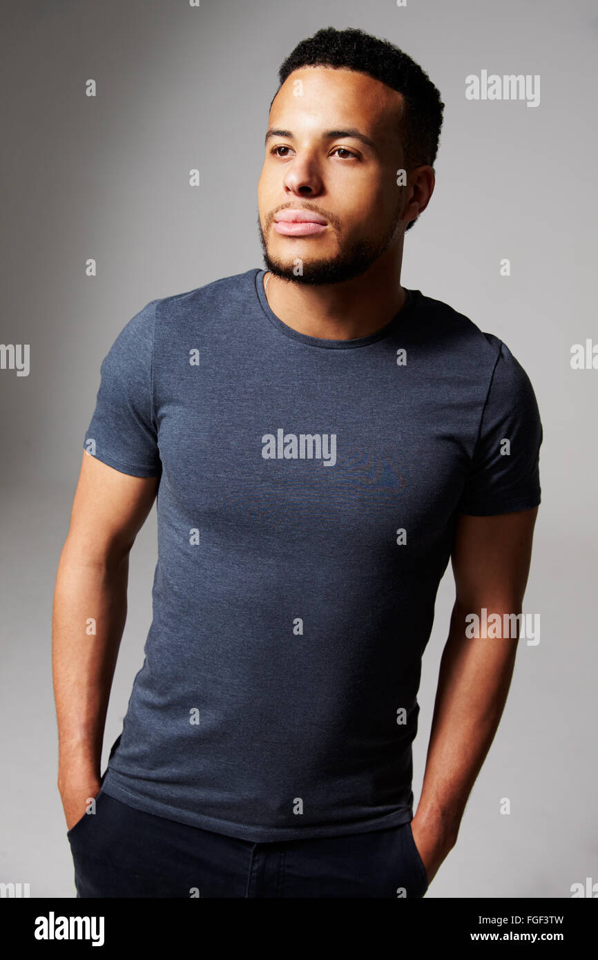 Studio Portrait Of Man Standing Against Grey Background Stock Photo - Alamy