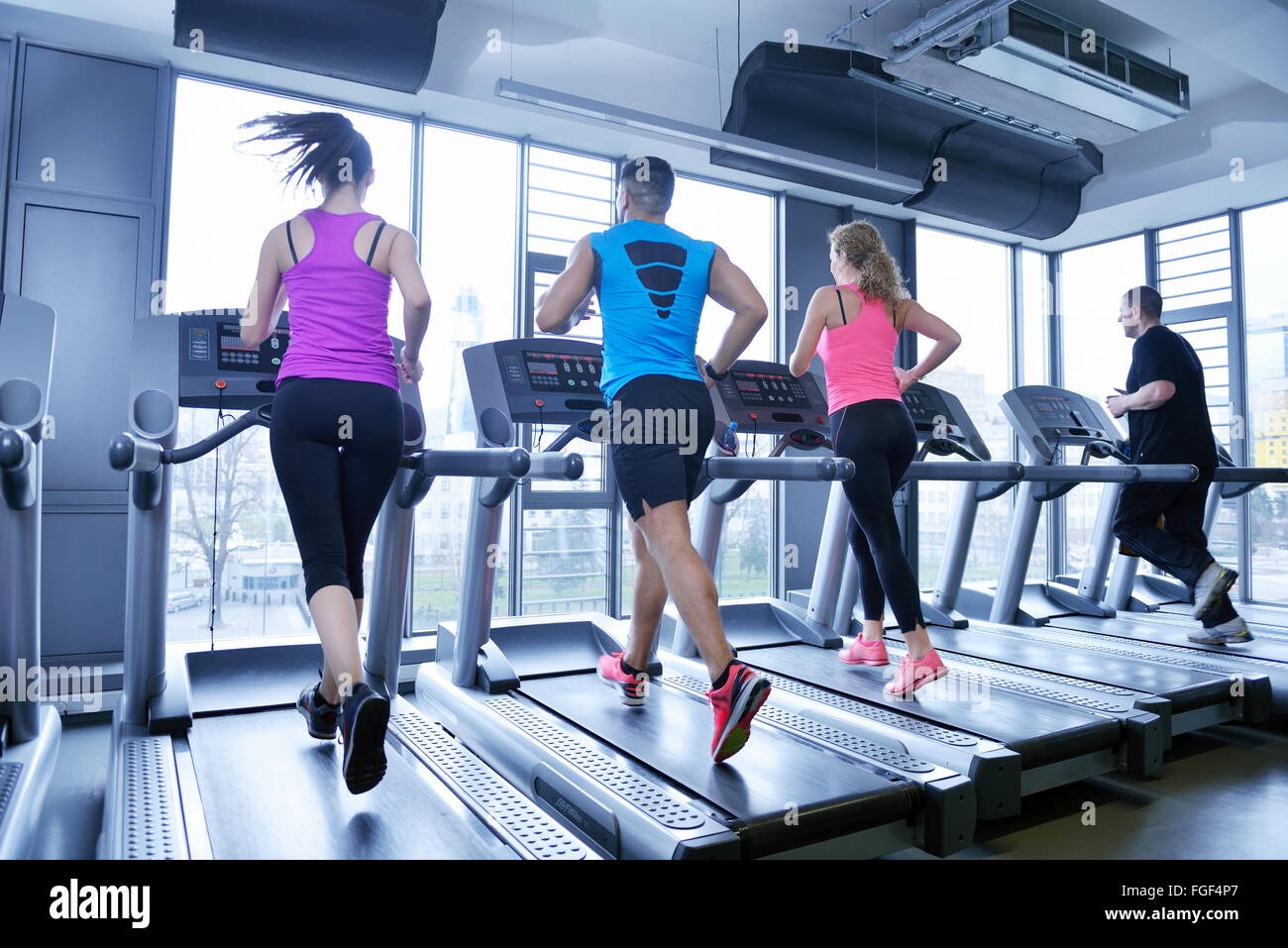 Group of people running on treadmills Stock Photo - Alamy