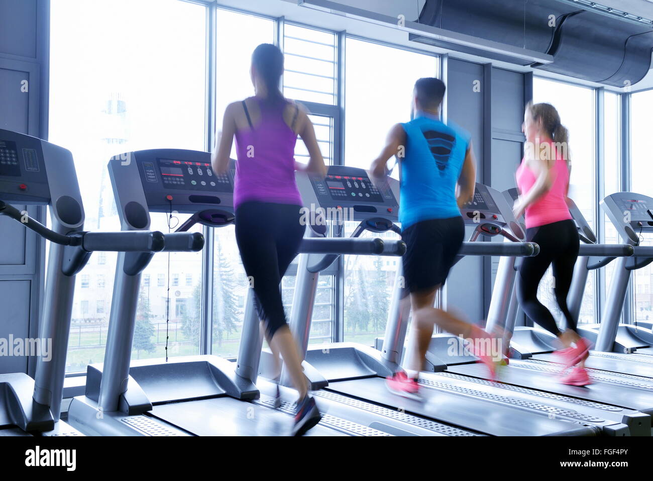 Group of people running on treadmills Stock Photo - Alamy