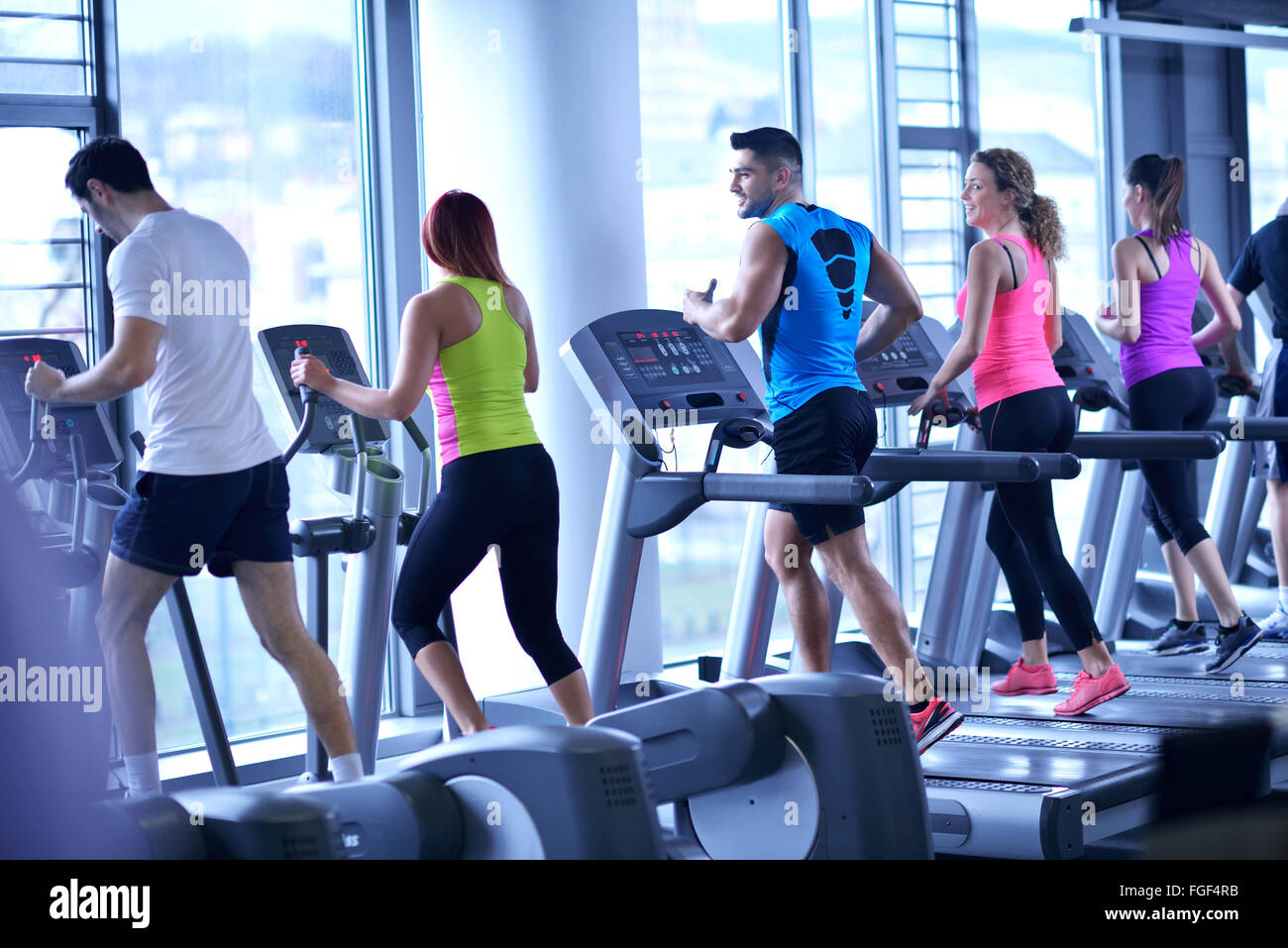 Group of people running on treadmills Stock Photo - Alamy
