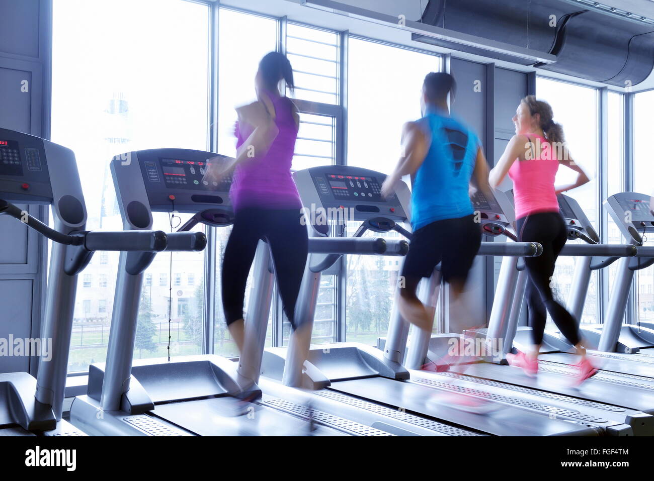 Group of people running on treadmills Stock Photo - Alamy