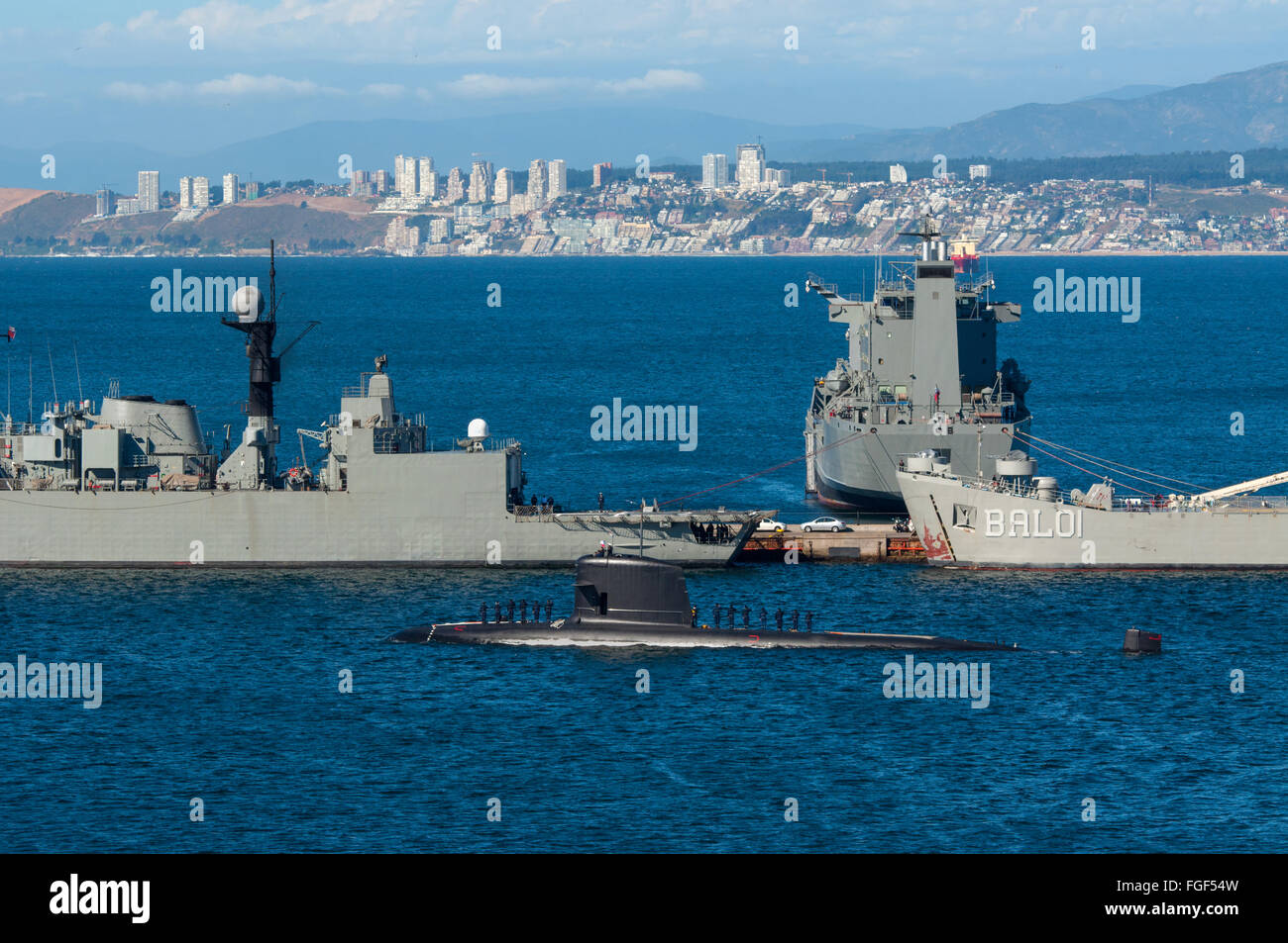 Crew stands on deck of a Navy submarine as it returns to port ...