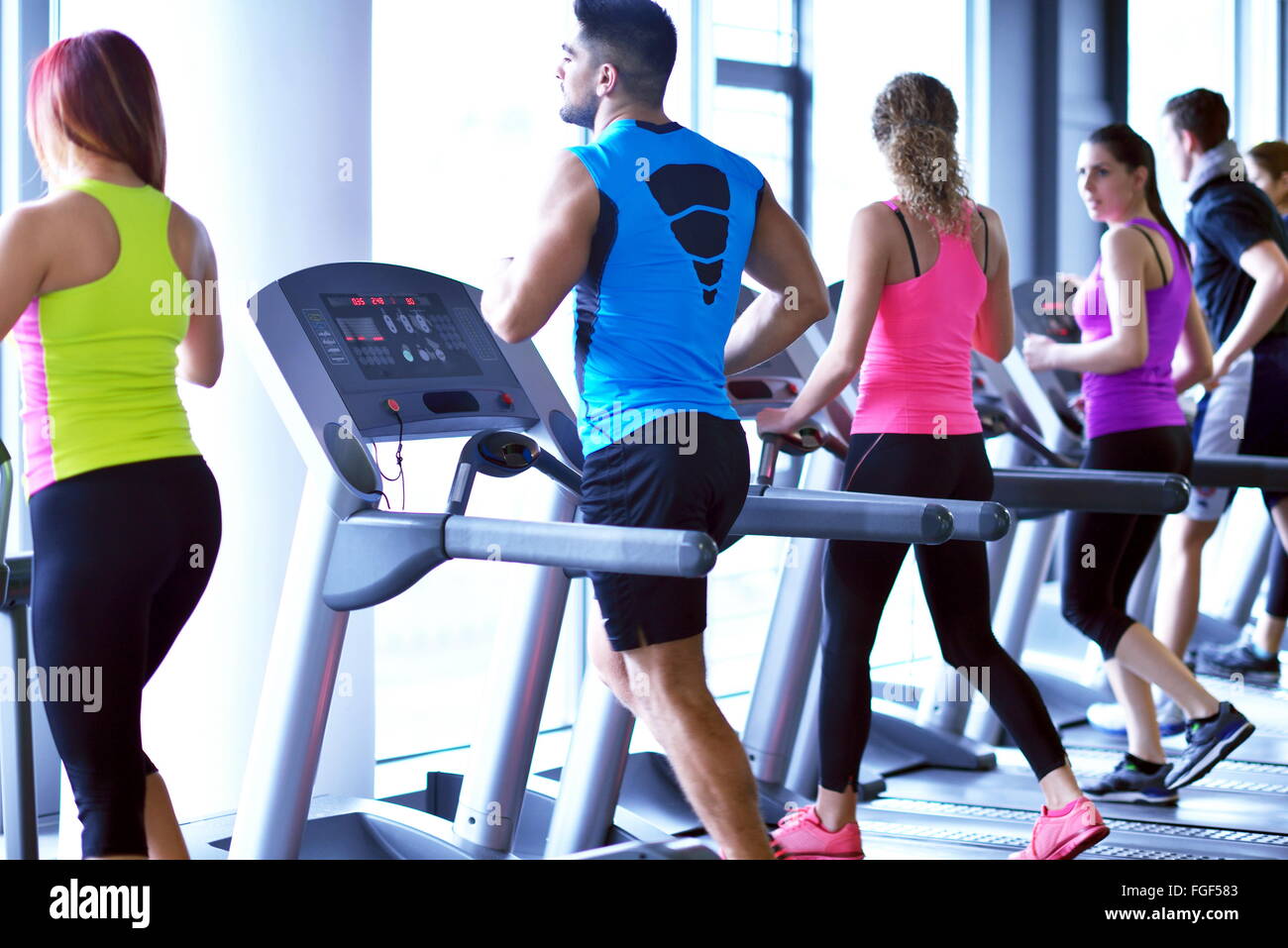 Group of people running on treadmills Stock Photo - Alamy