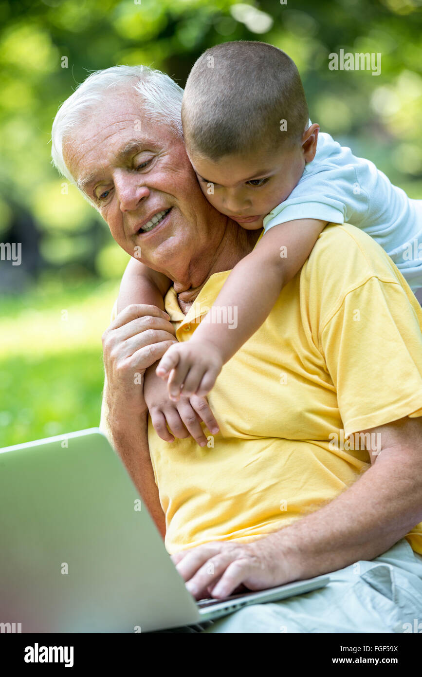 grandfather and child using laptop Stock Photo - Alamy