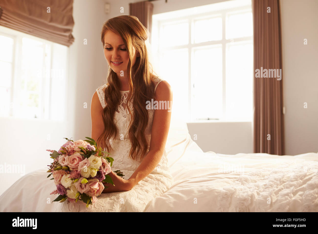 Bride sitting on bed hi-res stock photography and images - Alamy