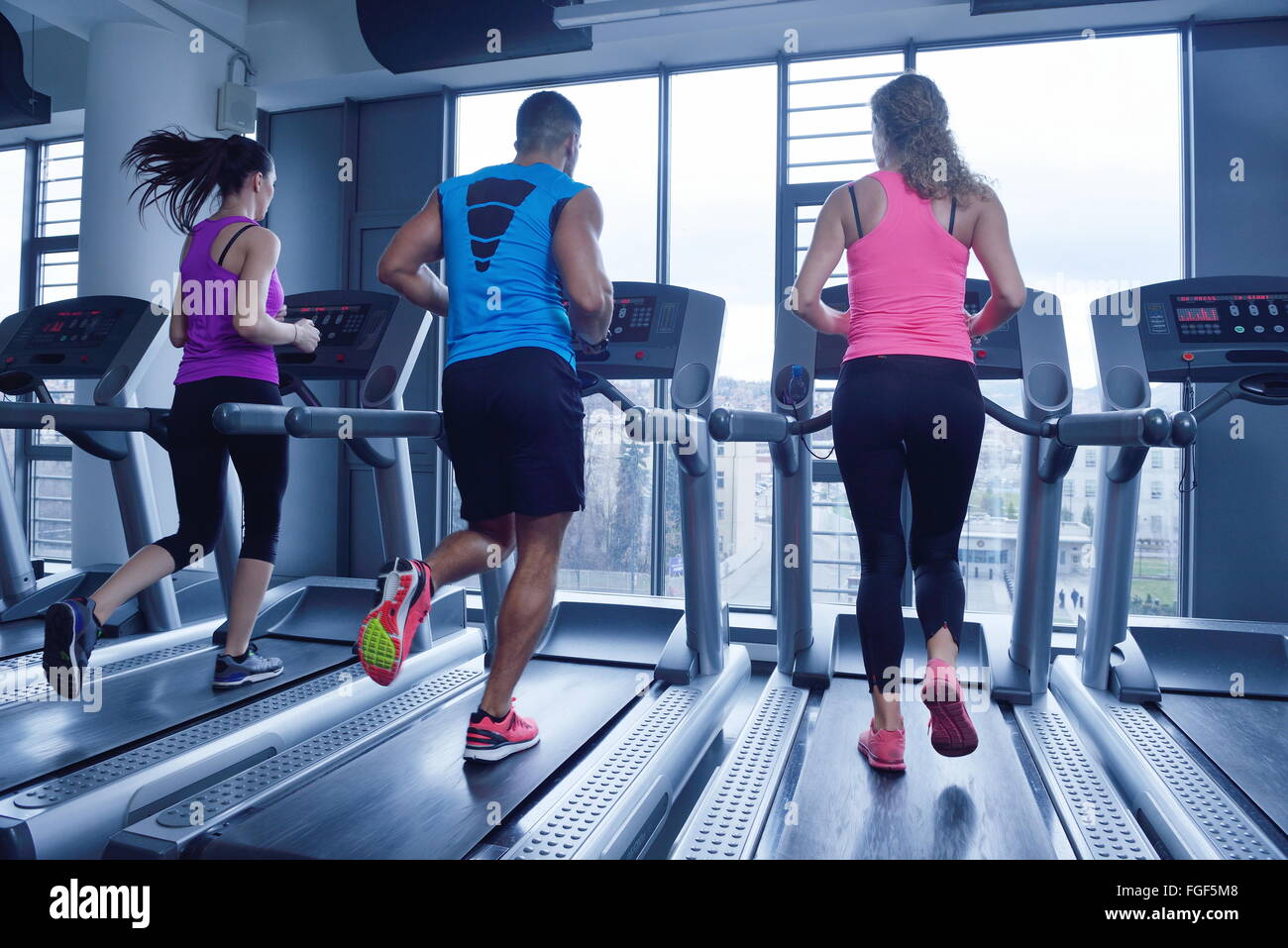 Group of people running on treadmills Stock Photo - Alamy