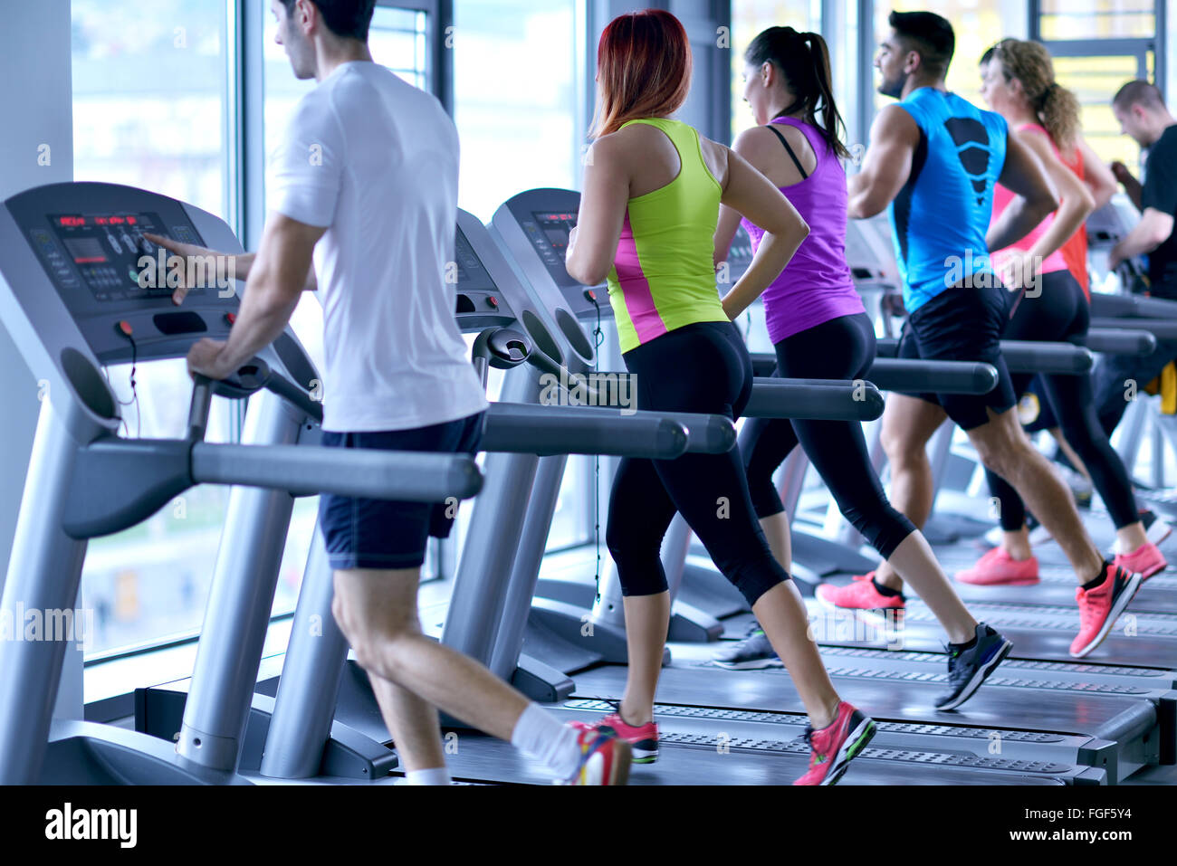 Group of people running on treadmills Stock Photo - Alamy