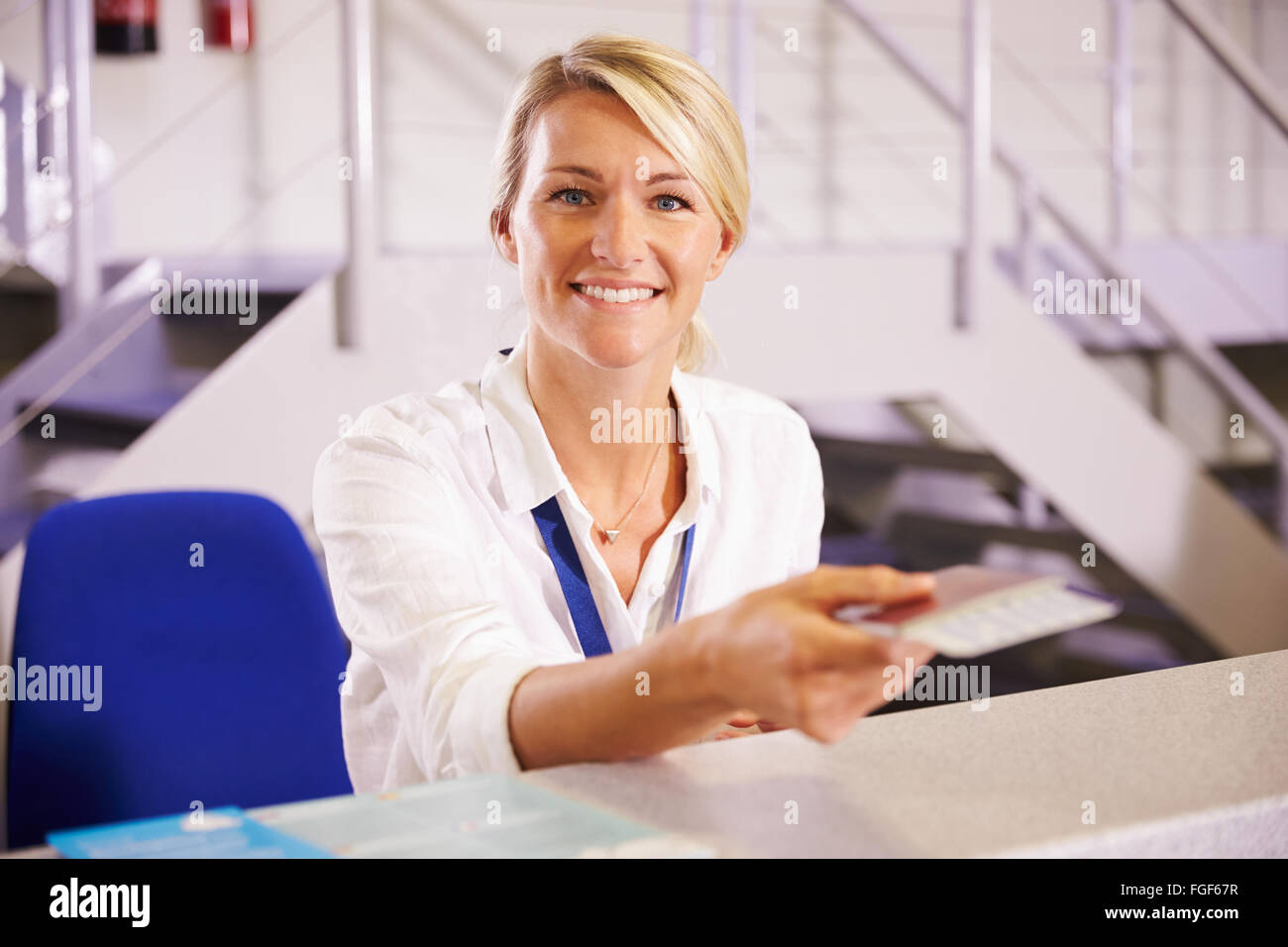 Portrait Of Staff At Airport Check In Desk Stock Photo - Alamy