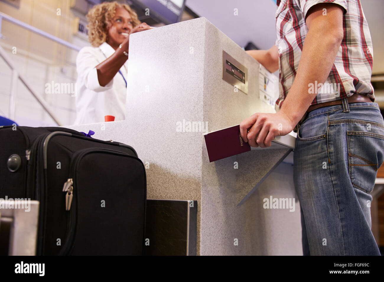 Passenger Weighing Luggage At Airport Check In Stock Photo - Alamy