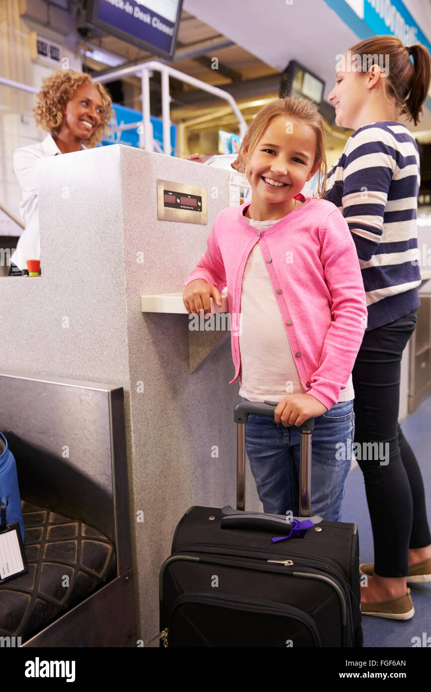 Mother And Daughter At Airport Check In Desk Stock Photo - Alamy