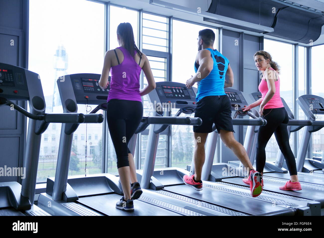Group of people running on treadmills Stock Photo - Alamy
