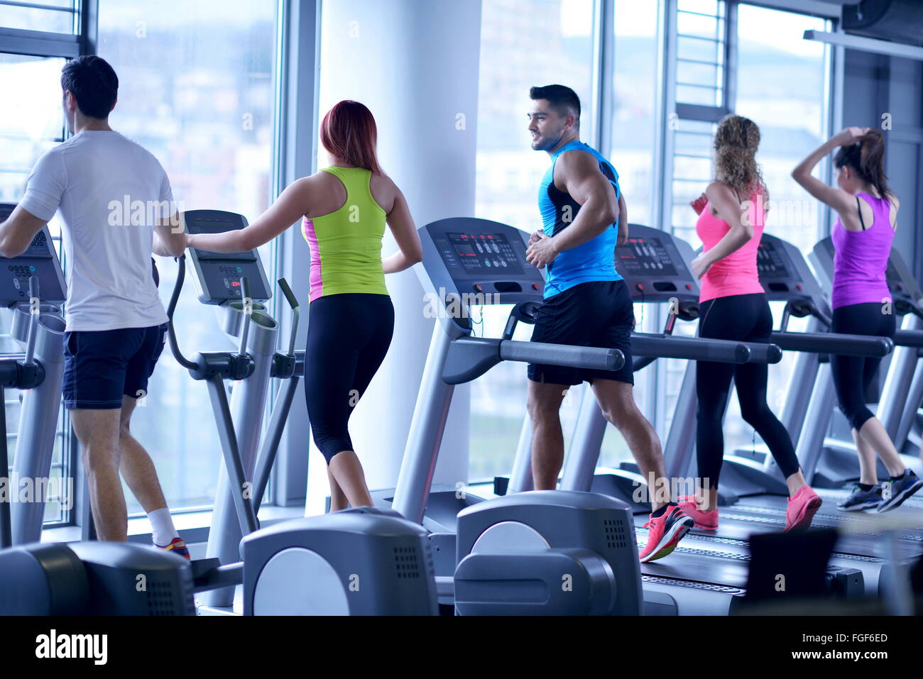 Group of people running on treadmills Stock Photo - Alamy