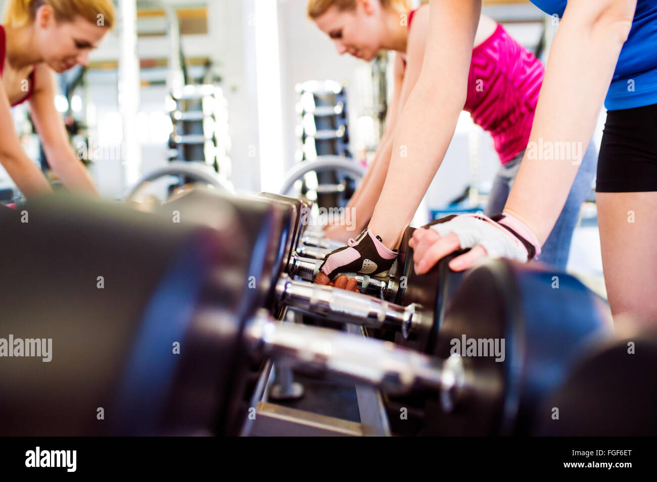 Detail of women in gym working out with weights Stock Photo - Alamy