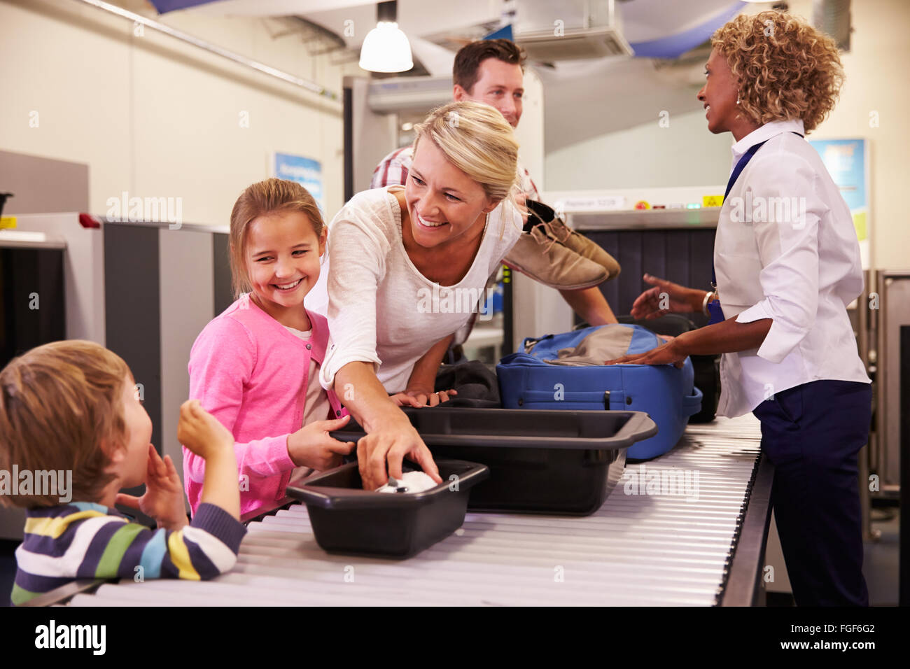 Family At Airport Passing Through Security Check Stock Photo - Alamy