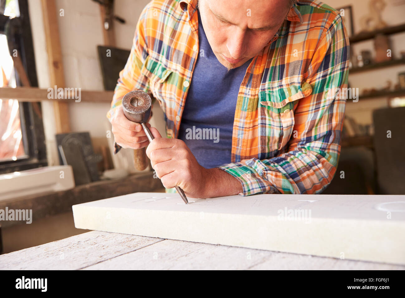 Stone Mason At Work On Carving In Studio Stock Photo - Alamy