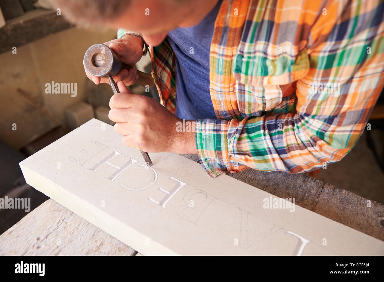 Stone Mason At Work On Carving In Studio Stock Photo - Alamy