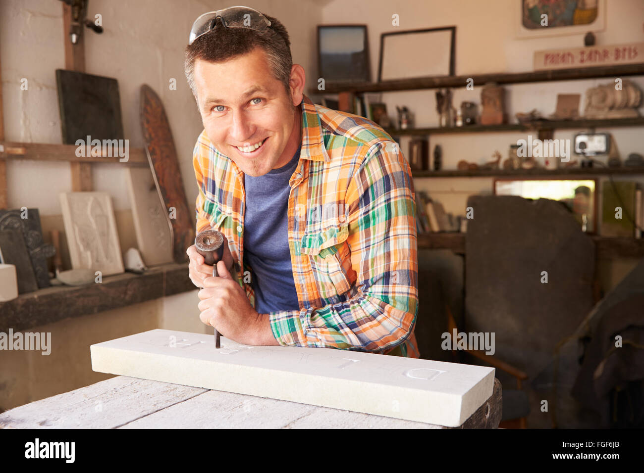 Stone Mason At Work On Carving In Studio Stock Photo - Alamy