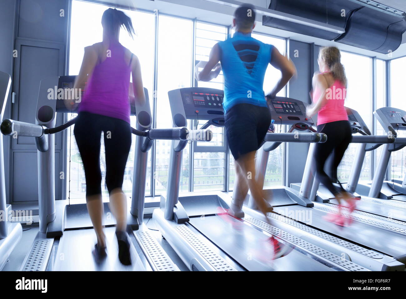Group of people running on treadmills Stock Photo - Alamy