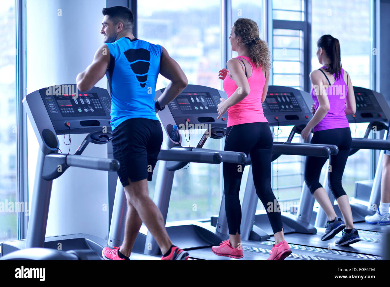 Group of people running on treadmills Stock Photo - Alamy