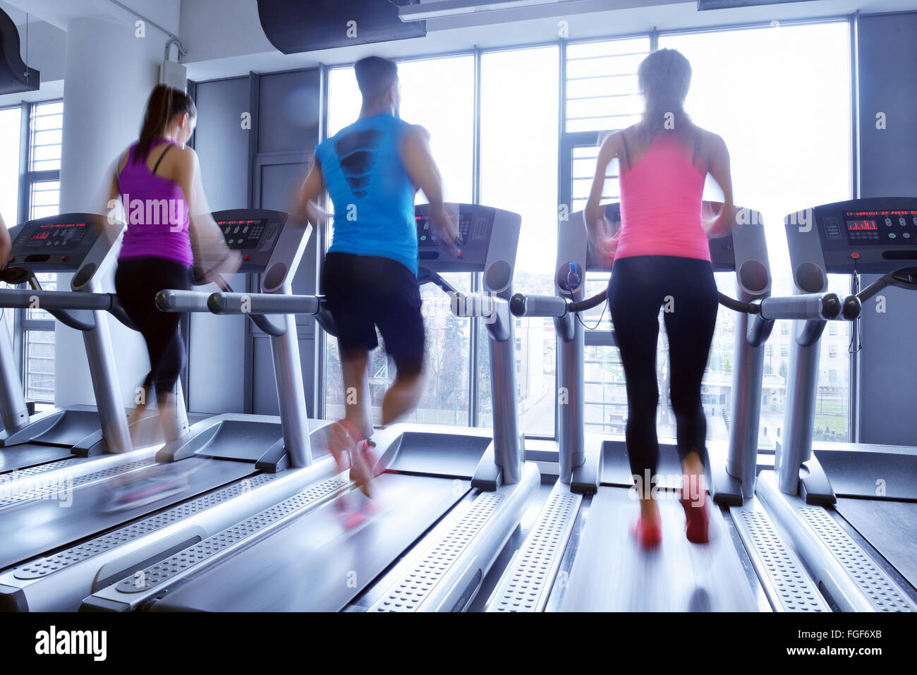 Group of people running on treadmills Stock Photo - Alamy