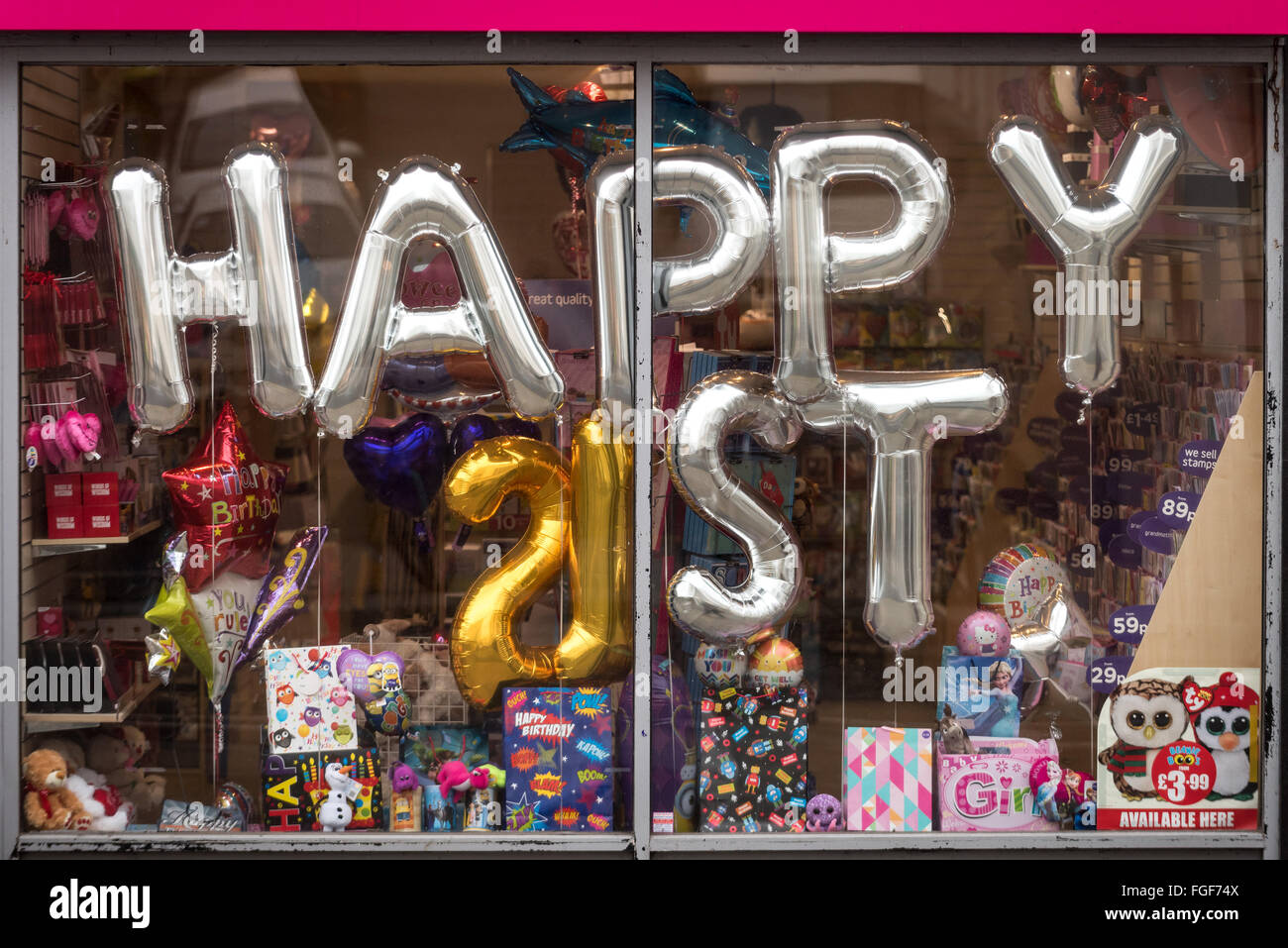 21st birthday display in a High Street shop window Stock Photo - Alamy
