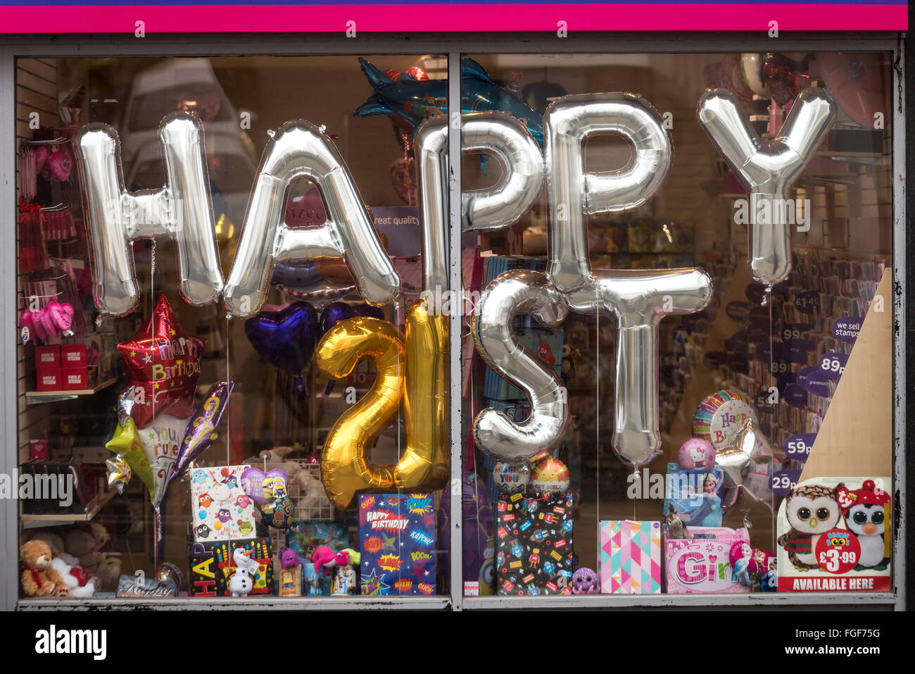 21st birthday display in a High Street shop window Stock Photo - Alamy