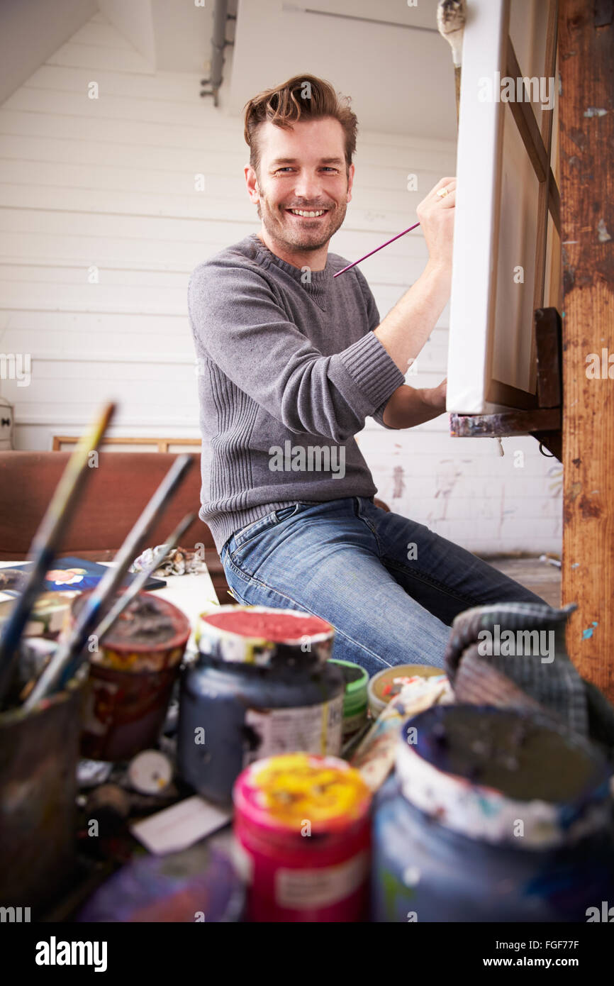 Portrait Of Male Artist Working On Painting In Studio Stock Photo - Alamy