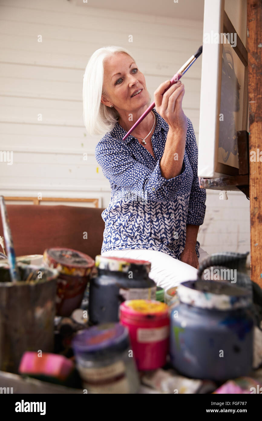 Female Artist Working On Painting In Studio Stock Photo - Alamy