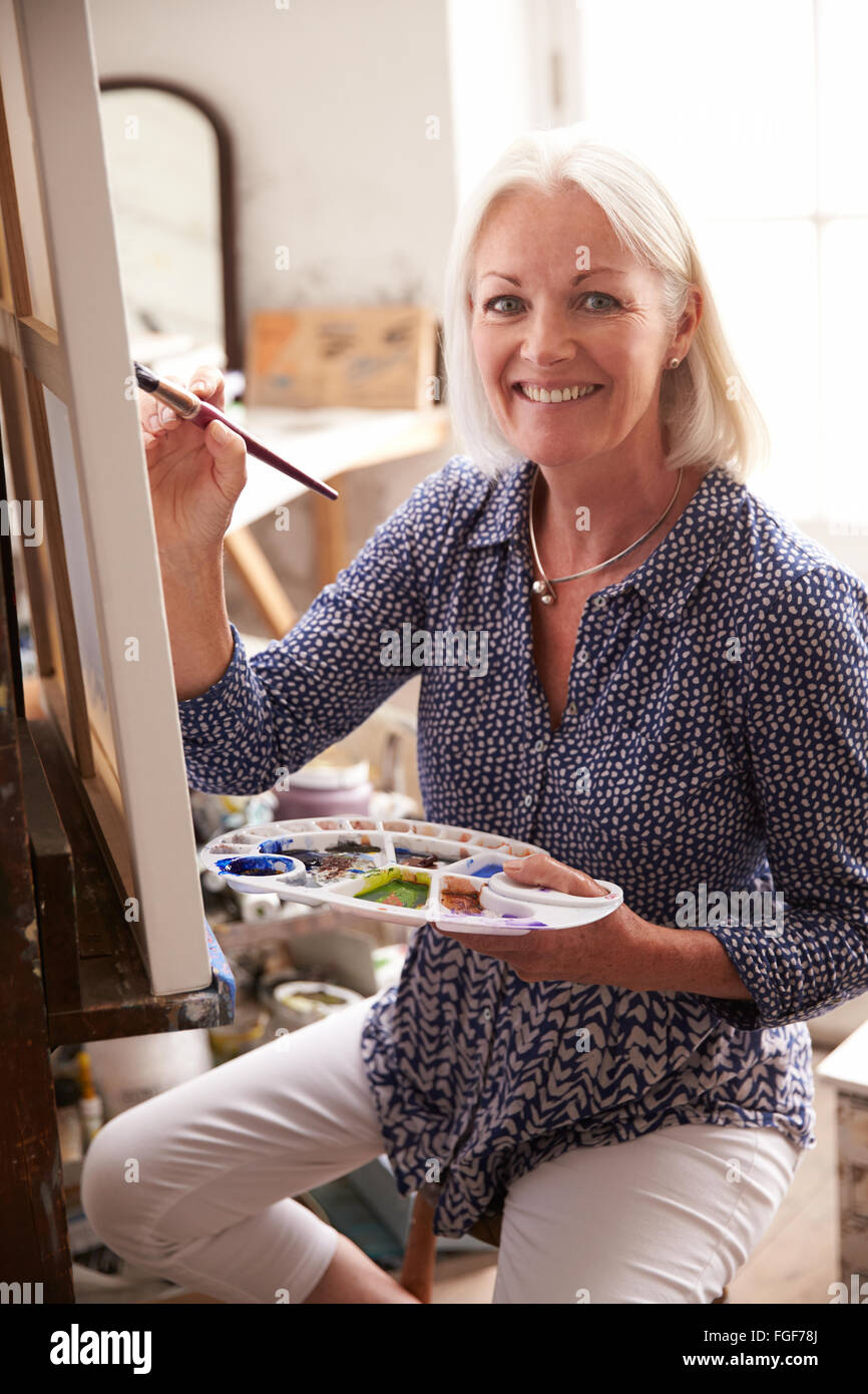 Portrait Of Female Artist Working On Painting In Studio Stock Photo - Alamy