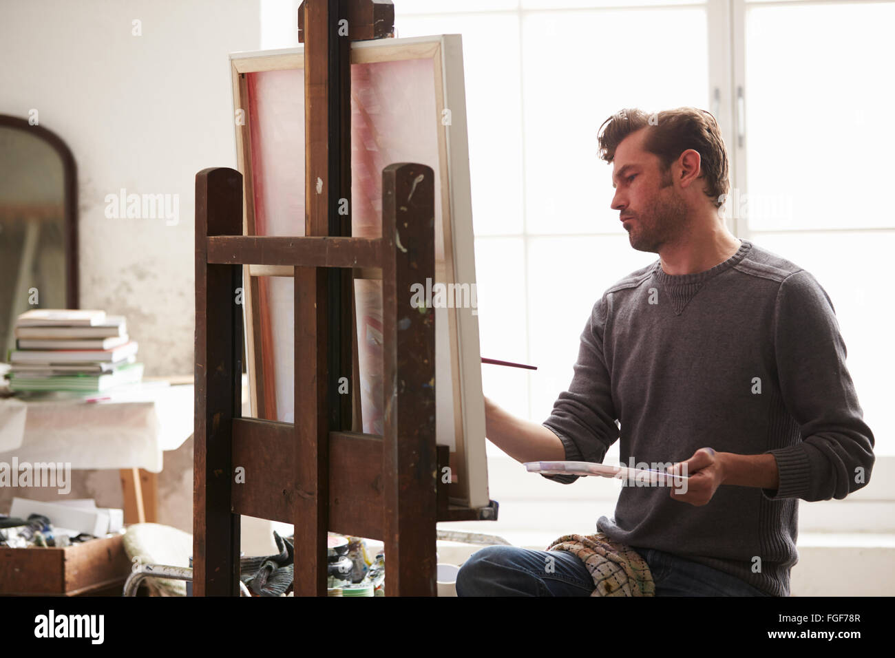 Male Artist Working On Painting In Studio Stock Photo - Alamy
